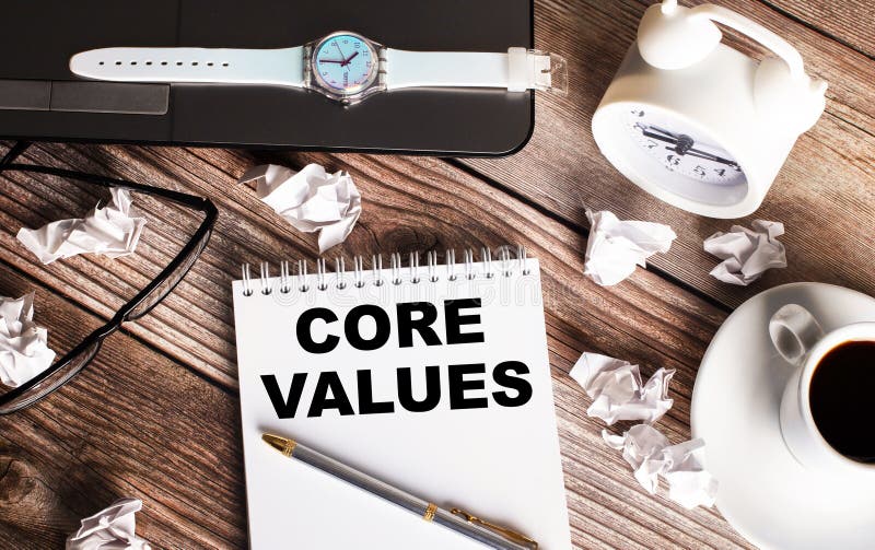 There is a Cup of Coffee on a Wooden Table, a Clock, Glasses and a ...