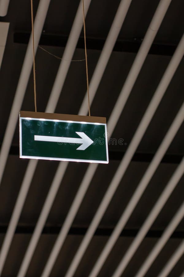 There is a Green Exit Sign Featuring an Arrow that Points Left Stock ...