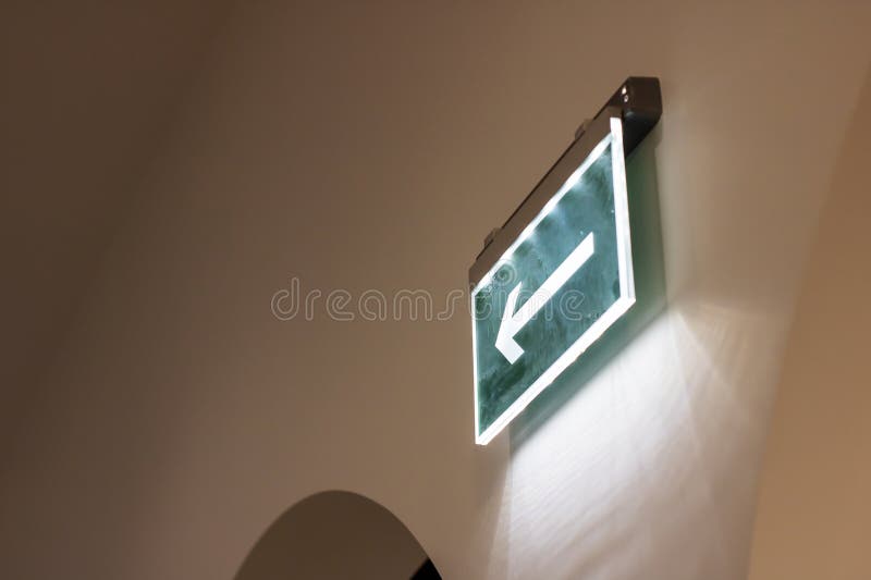 There is a Green Exit Sign Featuring an Arrow that Points Left Stock ...
