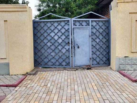 There are Grey Iron Gates with Forged Elements on the Street. Stock ...