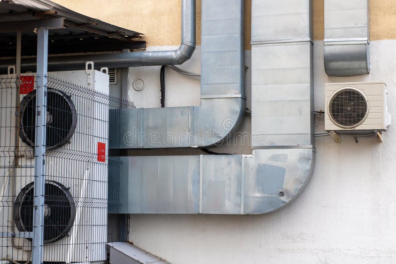 A Large Industrial Building that Has Many Pipes Protruding from it ...