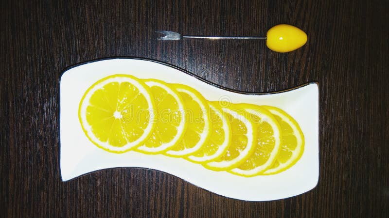 There are Lemon Slices on the Plate Stock Photo - Image of fork, juice ...