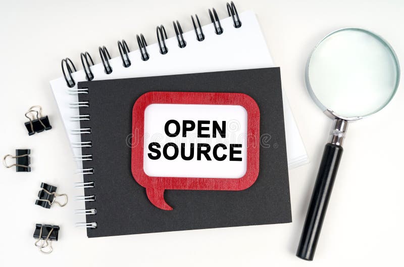 There is a Magnifying Glass, a Notebook and a Sign on the Table - OPEN ...