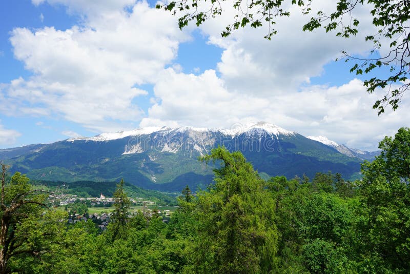 There is a Mountain Range in the Distance with Trees and Clouds Stock ...