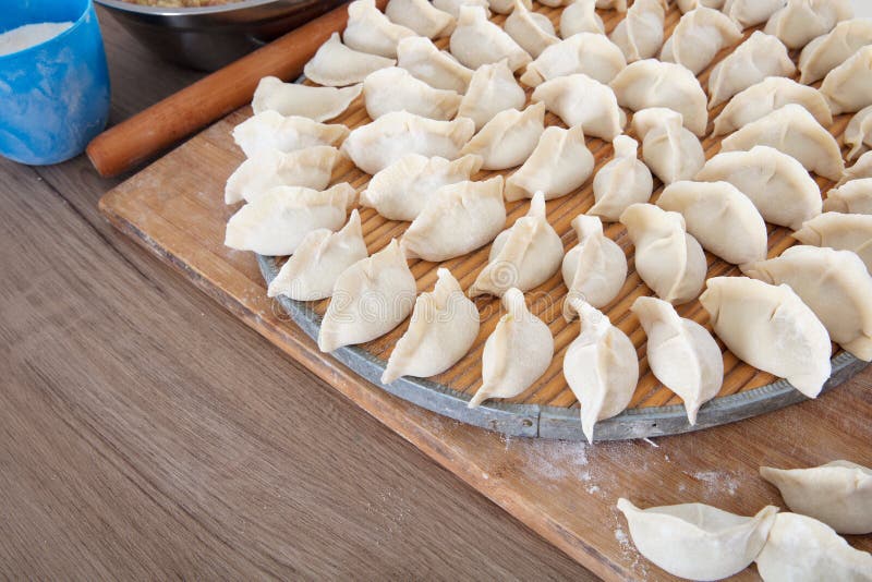 There are Neatly Wrapped Dumplings on a Circular Tray in the Kitchen ...