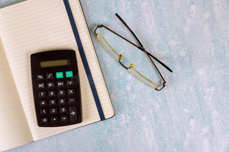 There are Notebook, Glasses, Calculator, on a Modern Office Table ...