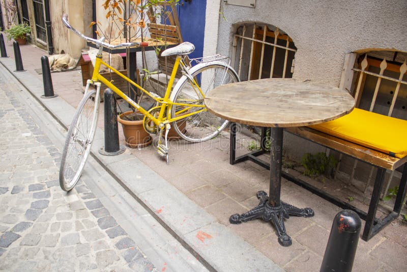 There is an Old Bicycle and Table and Chairs in Front of the Cafe ...