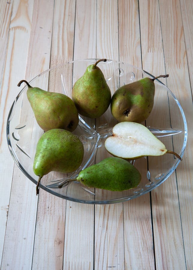 There are Pears on the Table in a Plate. One Pear Cut in Half Stock ...