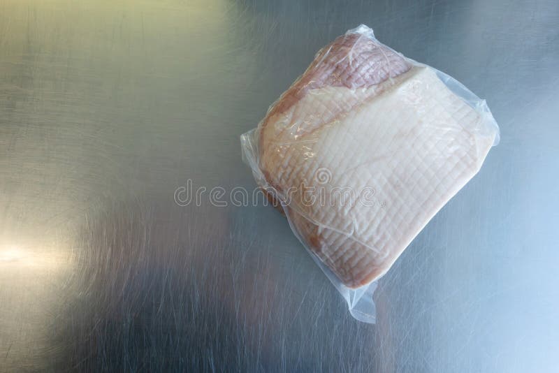 There is a Plastic Vacuum Bag Containing D-cut Ham on the Metal Kitchen ...