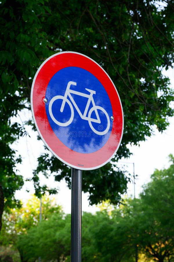There is a Red and Blue Sign that Prominently Features a Bicycle on it ...