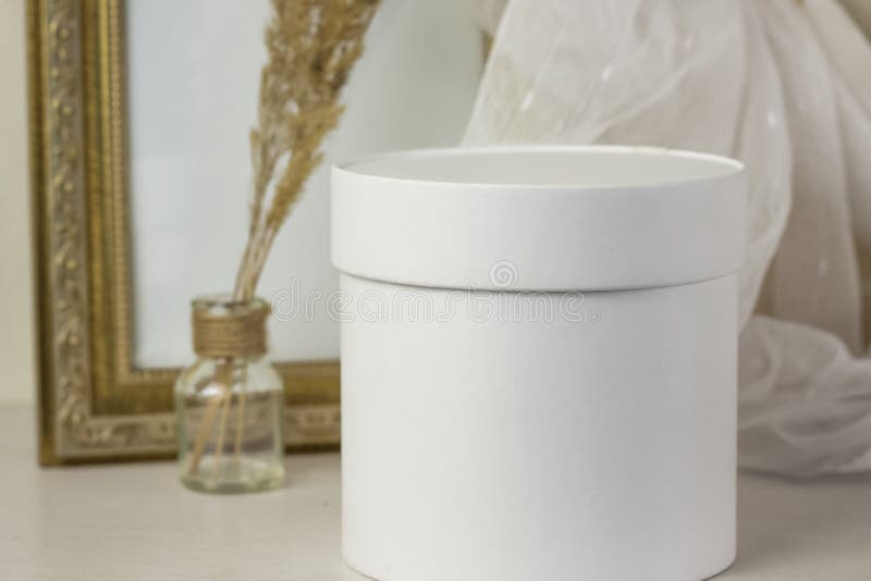 There is a Round Box on the Table. the Surface is Empty for Writing or ...