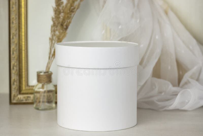 There is a Round Box on the Table. the Surface is Empty for Writing or ...