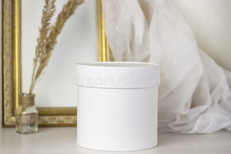 There is a Round Box on the Table. the Surface is Empty for Writing or ...