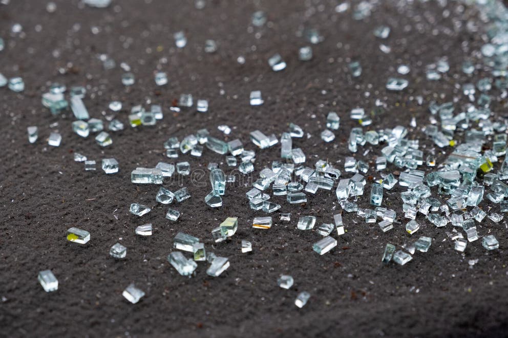 There are Scattered Pieces of Sharp Broken Glass Resting on a Dark ...