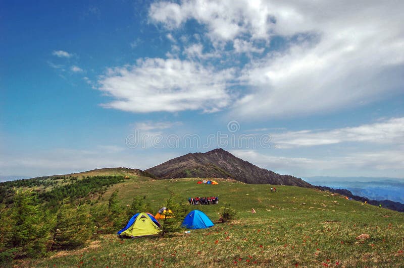 There are Several Camping Tents on the Green Lawn on the Hillside Stock ...