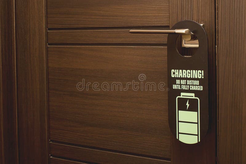 There is a Sign on the Door Charging Do Not Disturb until Fully Charged ...