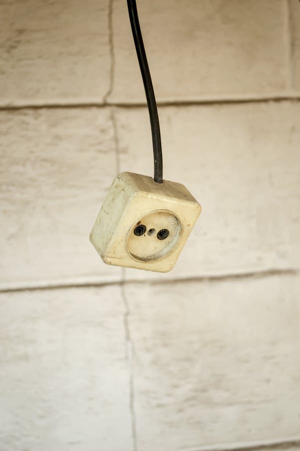 There is a Socket Hanging. the Socket Hangs on a Black Wire. the ...