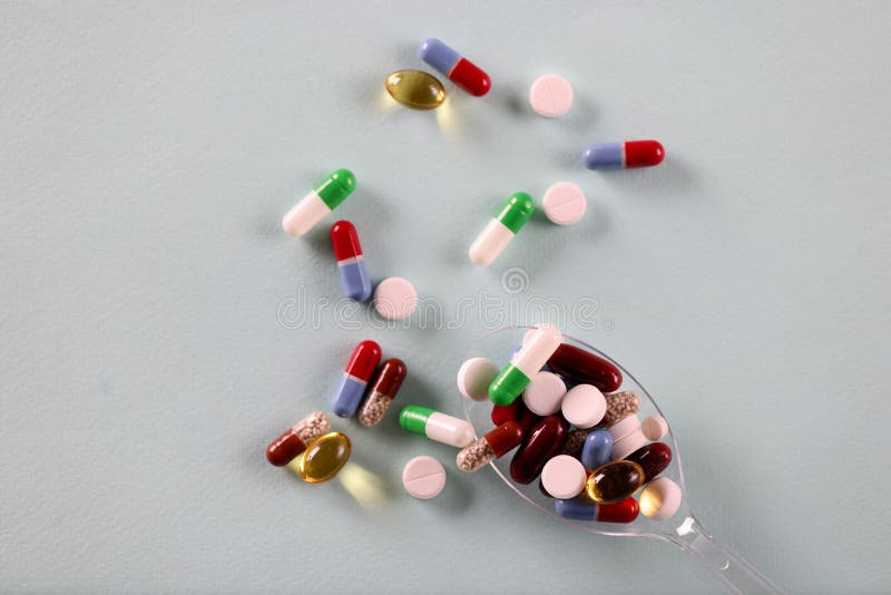 There is Spoon with Different Tablets on Table Stock Photo - Image of ...