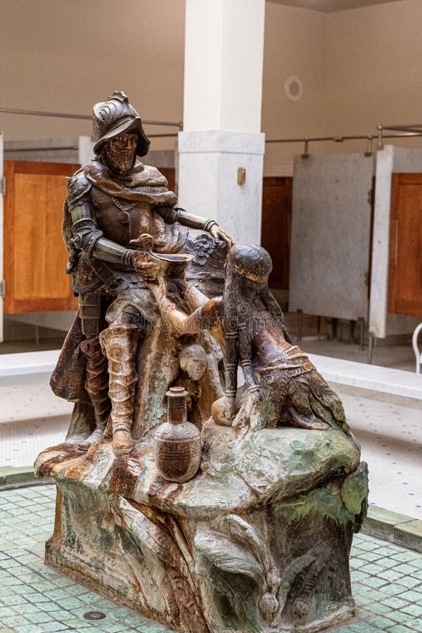 There is a Statue of People Sitting at the Base of a Building Editorial ...