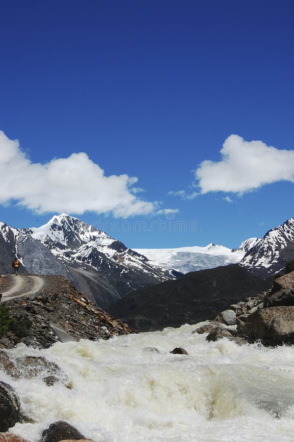 There is a Surging River Under the Cold Snow Mountain Stock Photo ...