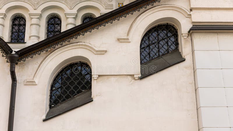 There are Two Elegantly Arched Windows Situated on the Side of a ...