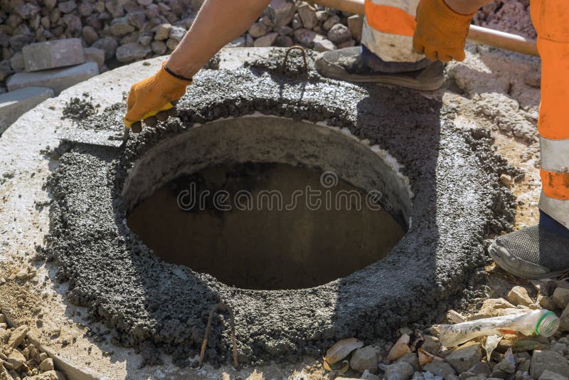 There is a Utility Worker Who is Constructing a Pit for a Septic Tank ...