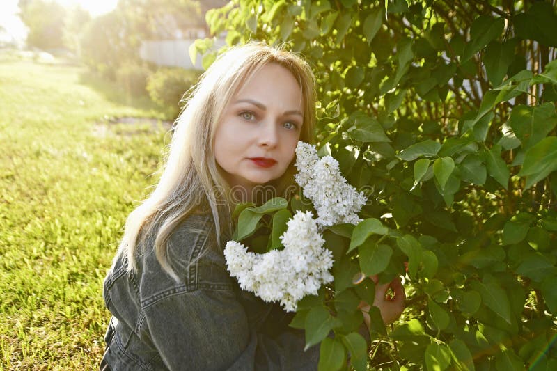 Spring Portraits of a Beautiful Woman Against a Background of Flowers ...