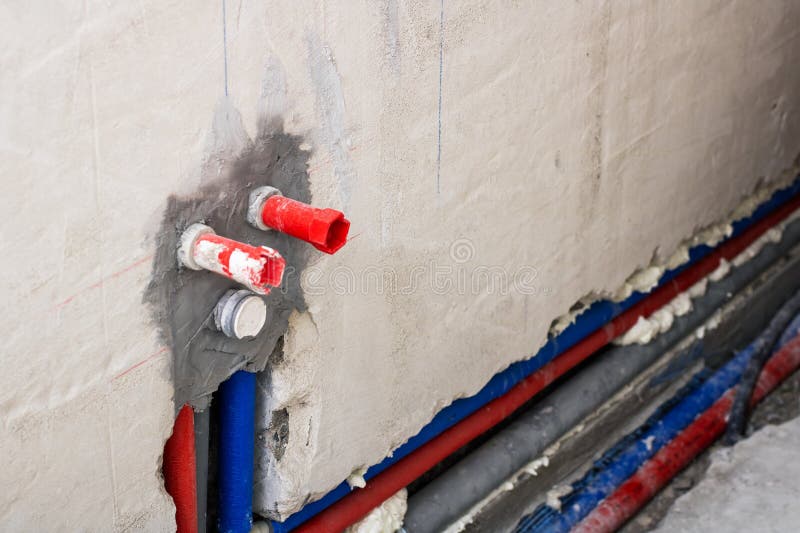 There is a Wall that Features a Multitude of Pipes Protruding from it ...