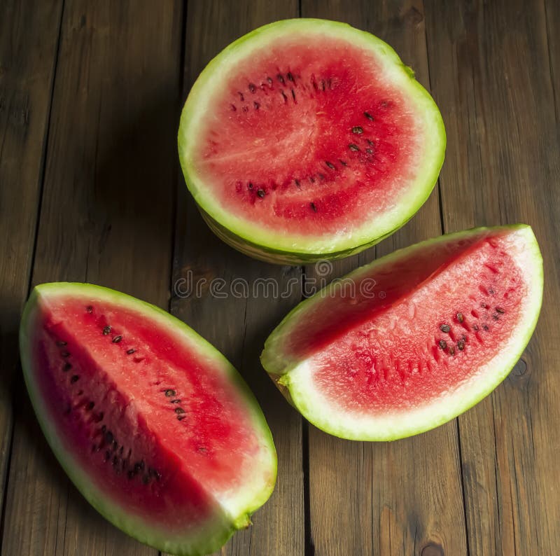 There is a Watermelon on a Wooden Table. WOODEN-based Red, Ripe ...