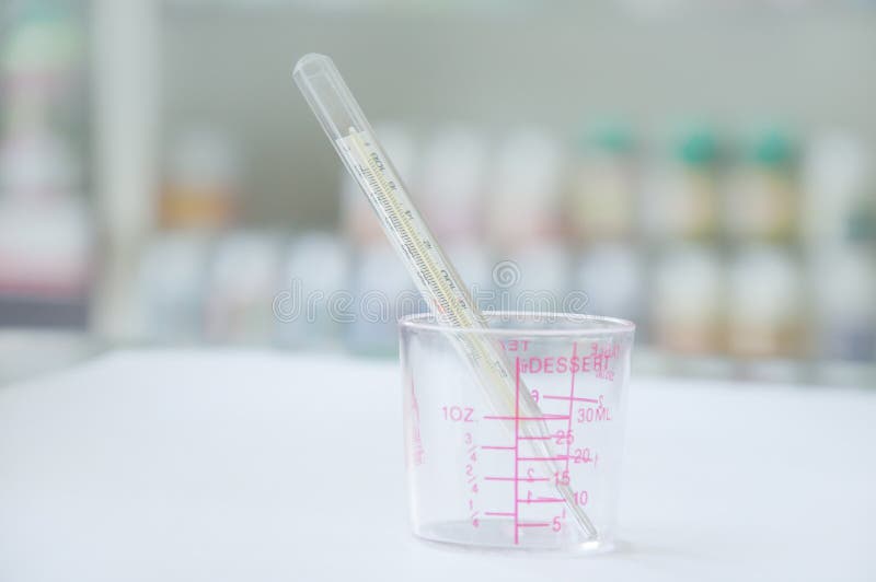 Thermometer in Beaker with Store Background Stock Image - Image of ...
