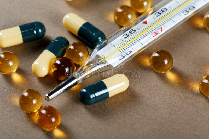 The Thermometer and Capsules with Medicines Stock Image - Image of ...