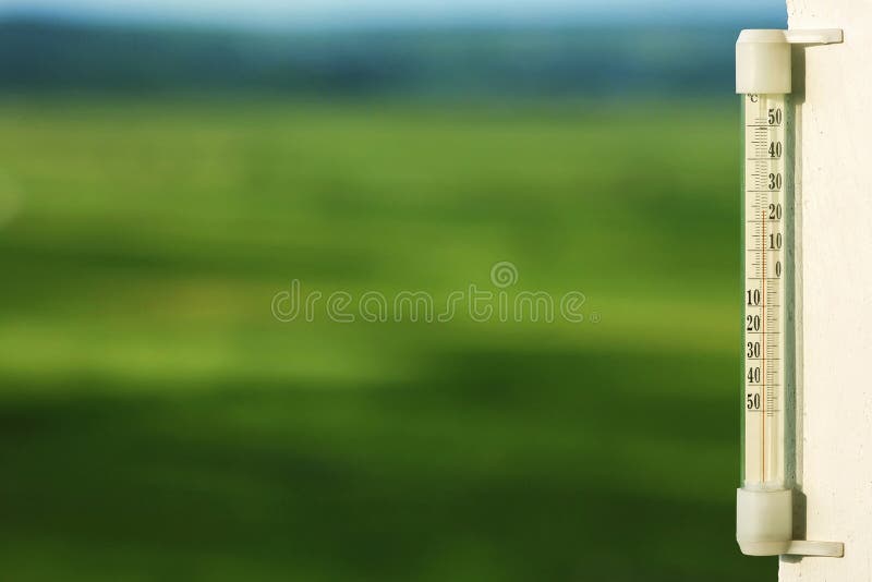 Thermometer Celsius Showing Warm Temperature on Blurred Green Stock ...
