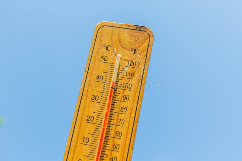 Thermometer Displaying High Summer Temperature on a Clear Sky Backgrou ...