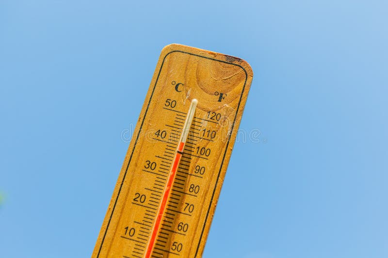 Thermometer Displaying High Summer Temperature on a Clear Sky Backgrou ...