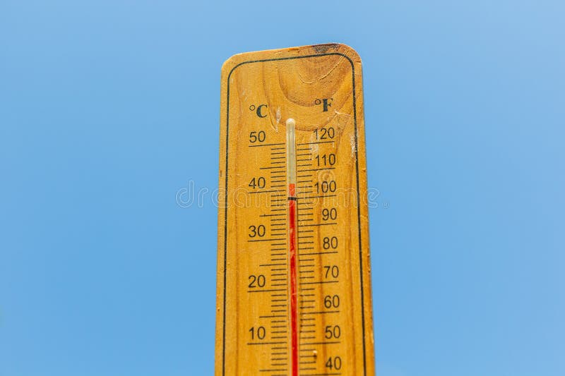 Thermometer Displaying High Summer Temperature on a Clear Sky Backgrou ...
