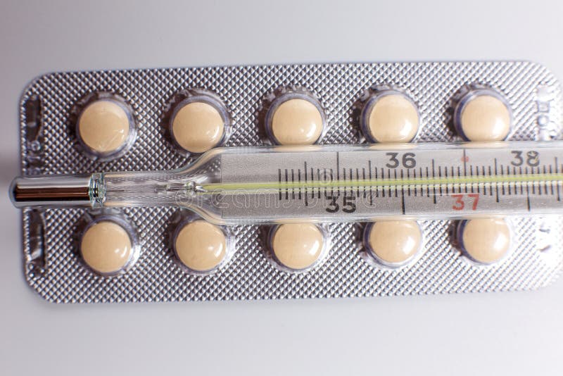 Thermometer for Measuring Body Temperature and Pills for Treatment ...