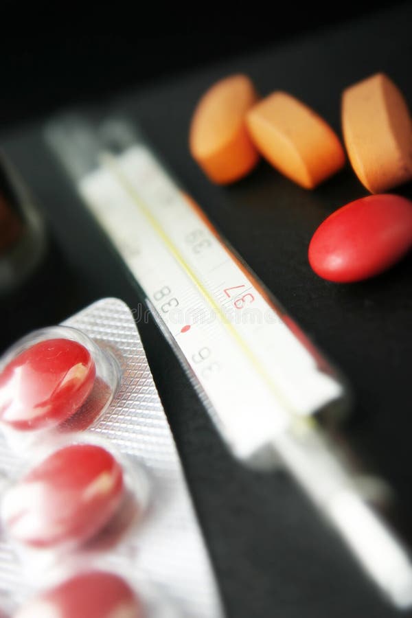 Thermometer and medication stock photo. Image of headache - 1074278