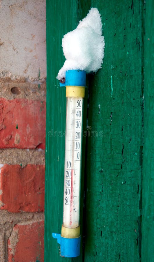 The Thermometer on the Wall of the House Shows a Low Temperature Stock ...