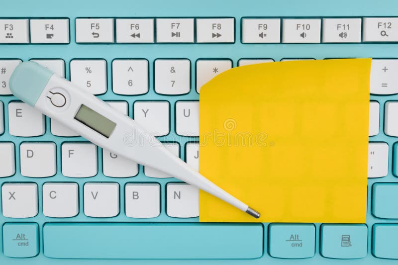 Thermometer and Yellow Sticky Note on a Computer Keyboard Stock Photo ...