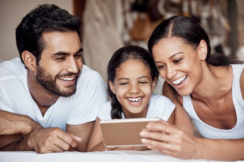 Theyre a Connected Family. a Happy Family Using a Cellphone Together at ...