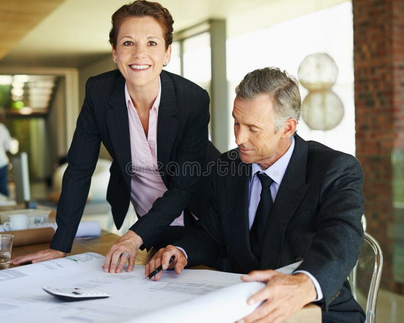 Theyre a Great Team of Planners. a Professional Businessman Going Over ... Theyre a Great Team of Planners. a Professional Businessman Going Over ...