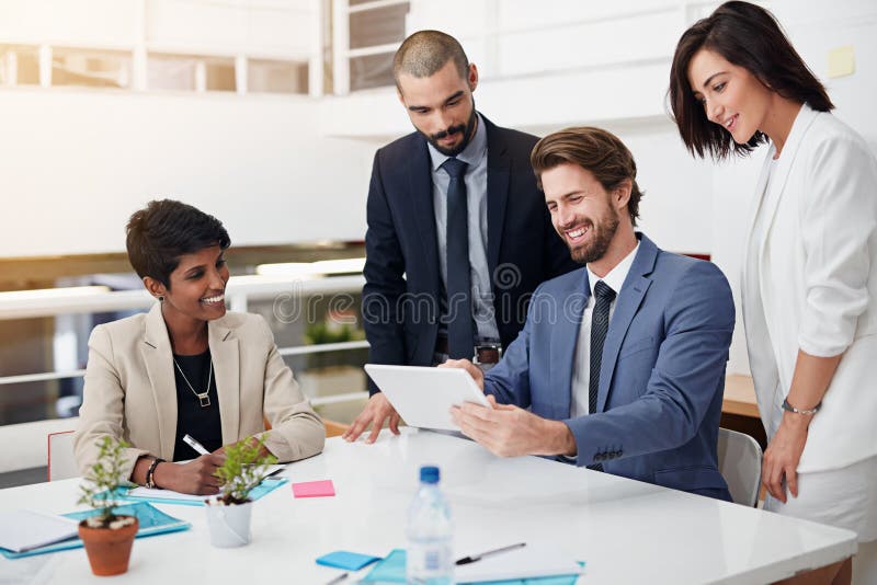 Theyre always Hard at Work. Businesspeople Using a Digital Tablet in an ...