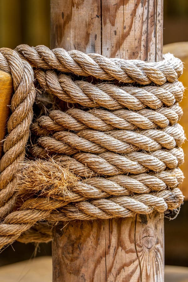 Thick Coiled Rope Wrapped Around a Weathered Wooden Post Stock Image ...