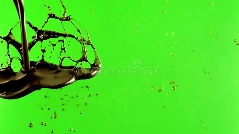 A Thick, Dark Liquid Splashes and Splatters on a Green Background ...