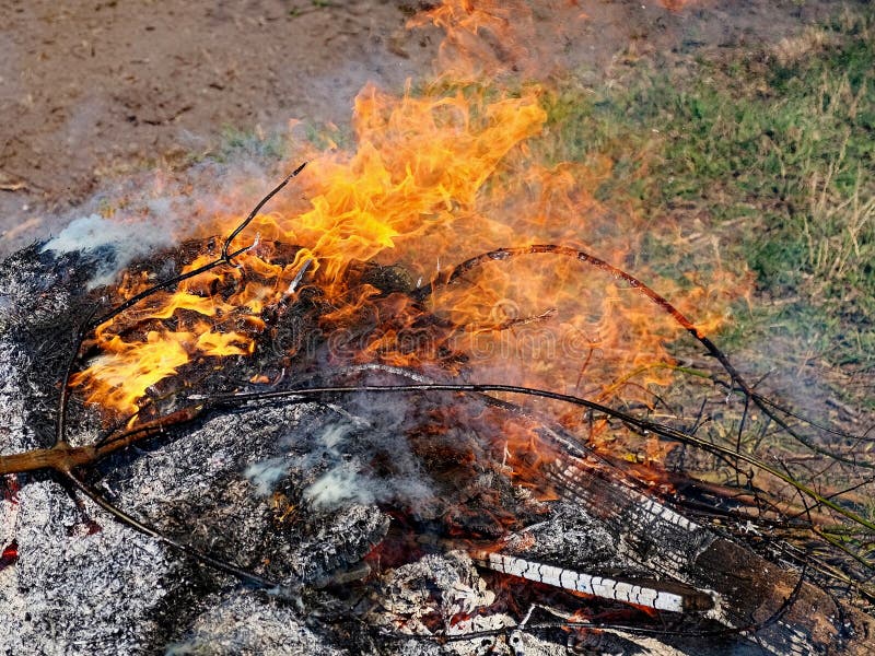 Thick Grey Smoke is Rising into the Air from the Source of the Flame ...