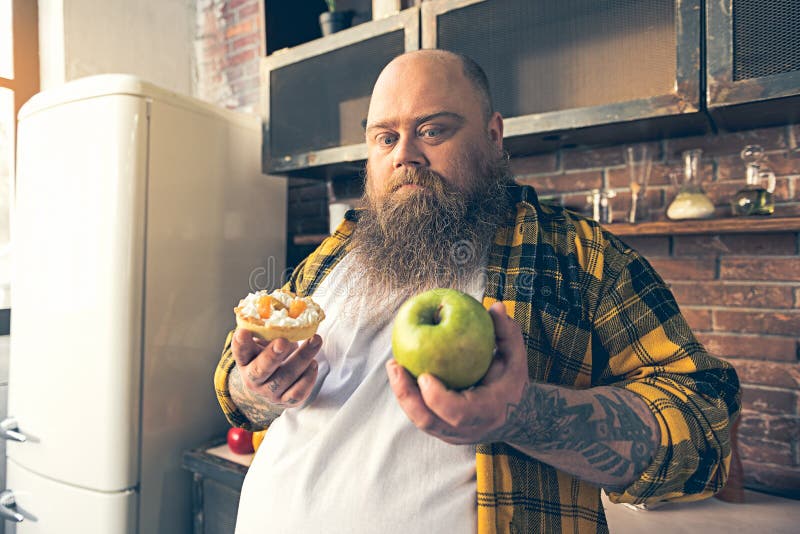 Thick Guy Choosing between Fruit and Cake Stock Photo - Image of ...