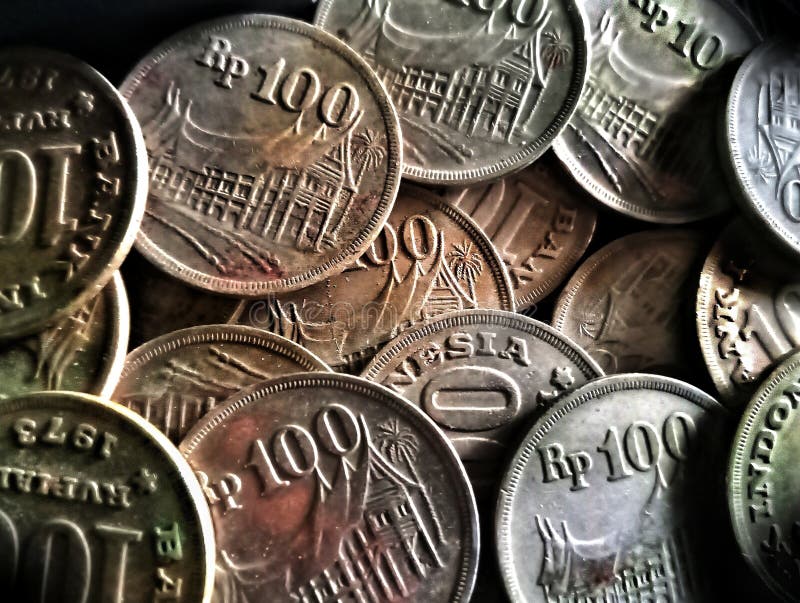 Thick Indonesian 100 Rupiah Coins Scattered in the Dark Light Stock ...