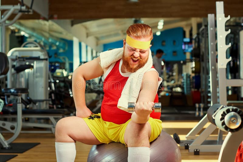A Funny Fat Man Doing Exercises in the Gym. Stock Image - Image of ...