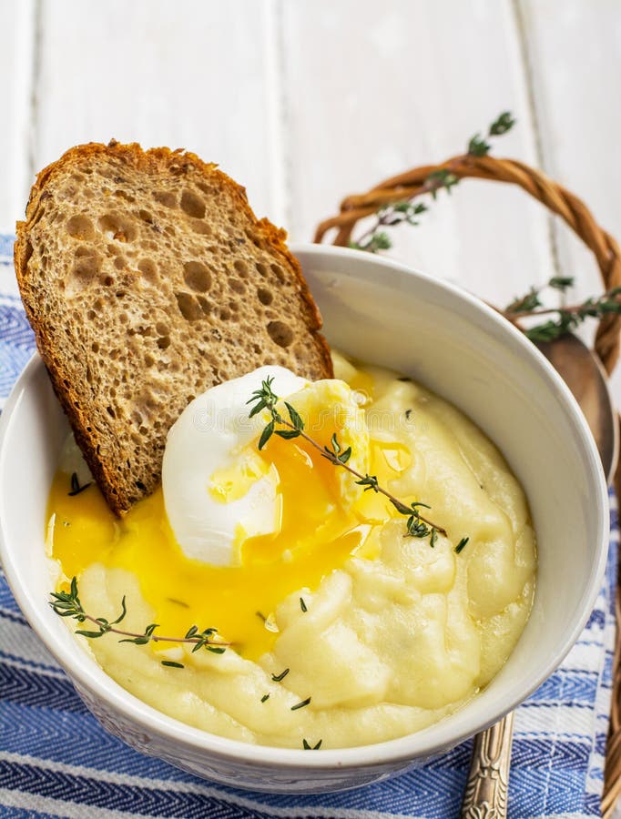 Thick Mashed Potatoes with Poached Egg and a Slice of Bread Thyme Stock ...