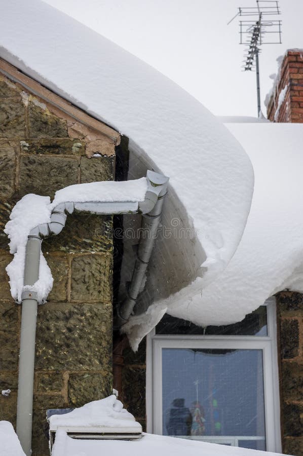 Thick Snow Causing Damage To House Roof and Guttering. Stock Photo ...